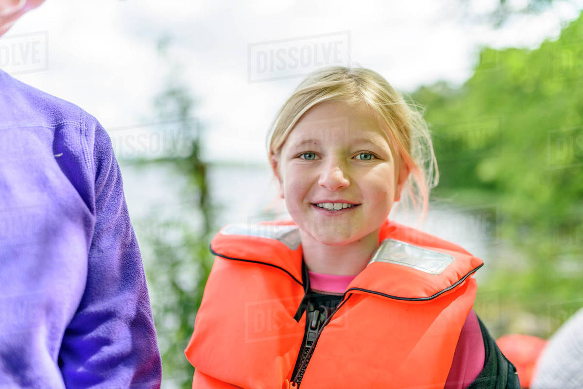 Portrait of girl wearing life jacket - Royalty-free Stock Photo | Dissolve