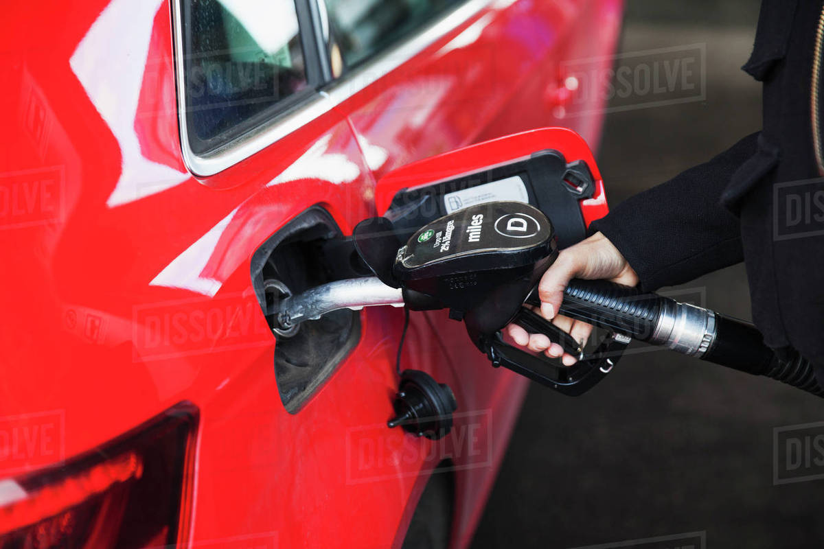 Woman pumping gas - Royalty-free Stock Photo | Dissolve