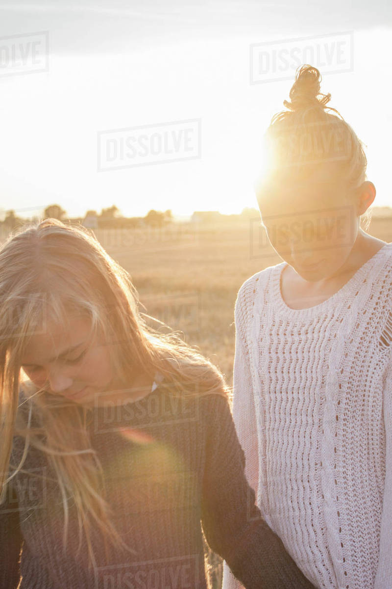 Two sisters at sunset - Royalty-free Stock Photo | Dissolve