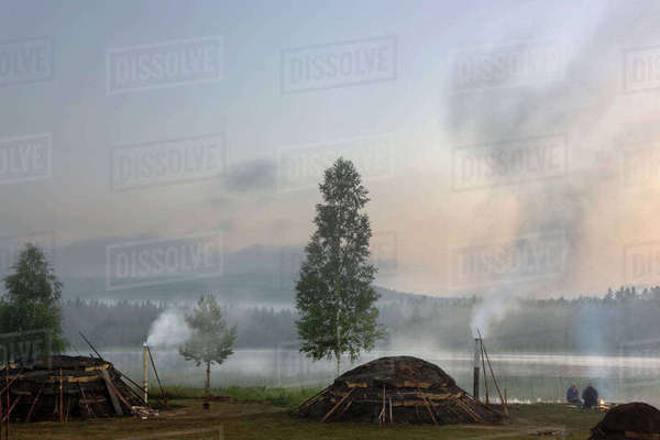 Smoking furnaces at dusk - Stock Photo - Dissolve