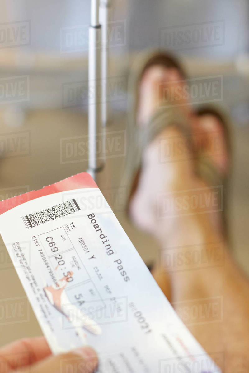 Hand with boarding pass - Stock Photo - Dissolve