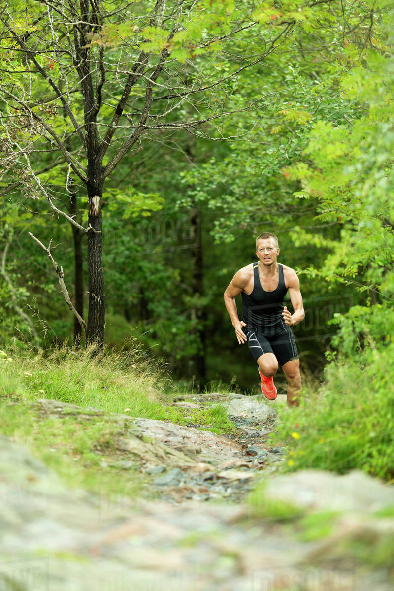 Man running in forest - Royalty-free Stock Photo | Dissolve