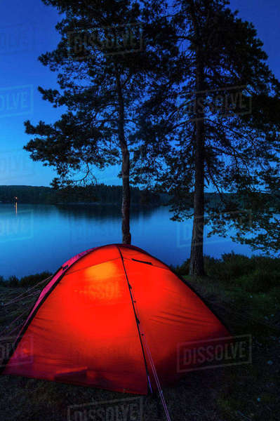 Red tent at dusk - Stock Photo - Dissolve