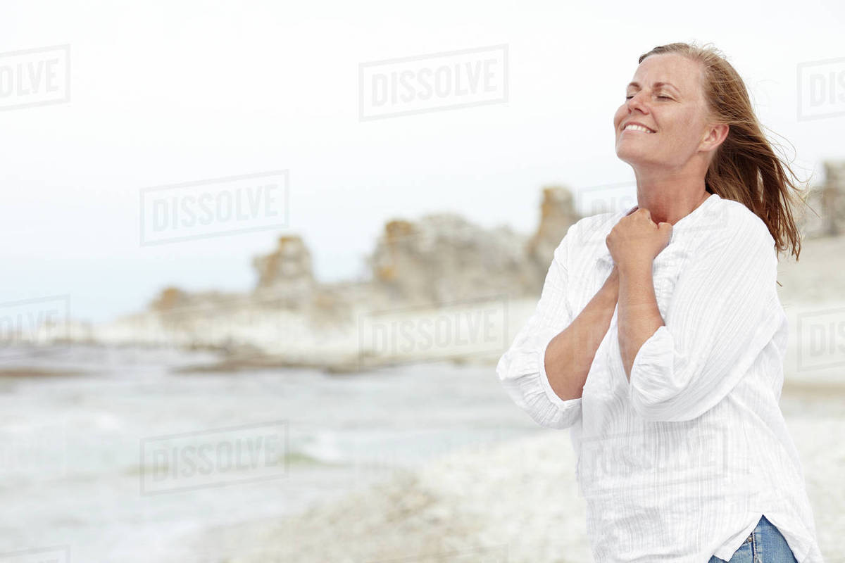 Smiling woman on beach - Royalty-free Stock Photo | Dissolve