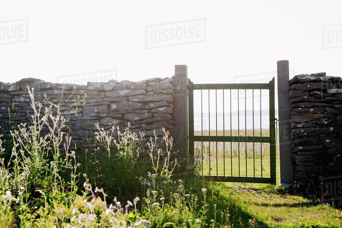 Gate in stone wall - Stock Photo - Dissolve