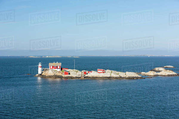 Lighthouse on rocky island - Royalty-free Stock Photo | Dissolve