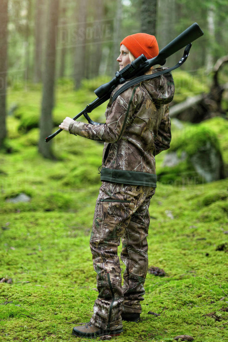 Woman hunting in forest - Royalty-free Stock Photo | Dissolve