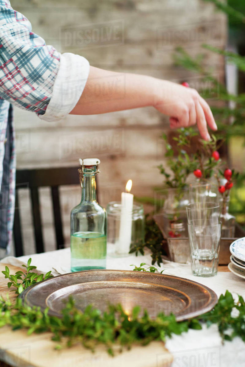 Person preparing table setting - Stock Photo - Dissolve
