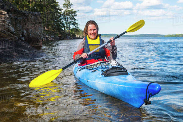 Mature woman kayaking - Royalty-free Stock Photo | Dissolve