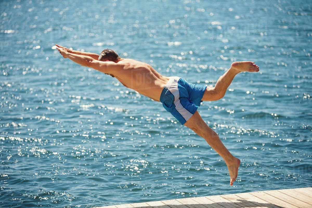 Man jumping into sea - Royalty-free Stock Photo | Dissolve