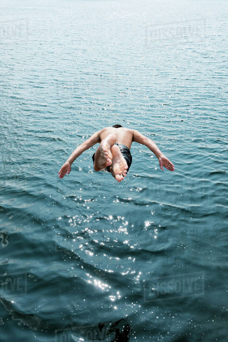 Man jumping into sea - Royalty-free Stock Photo | Dissolve
