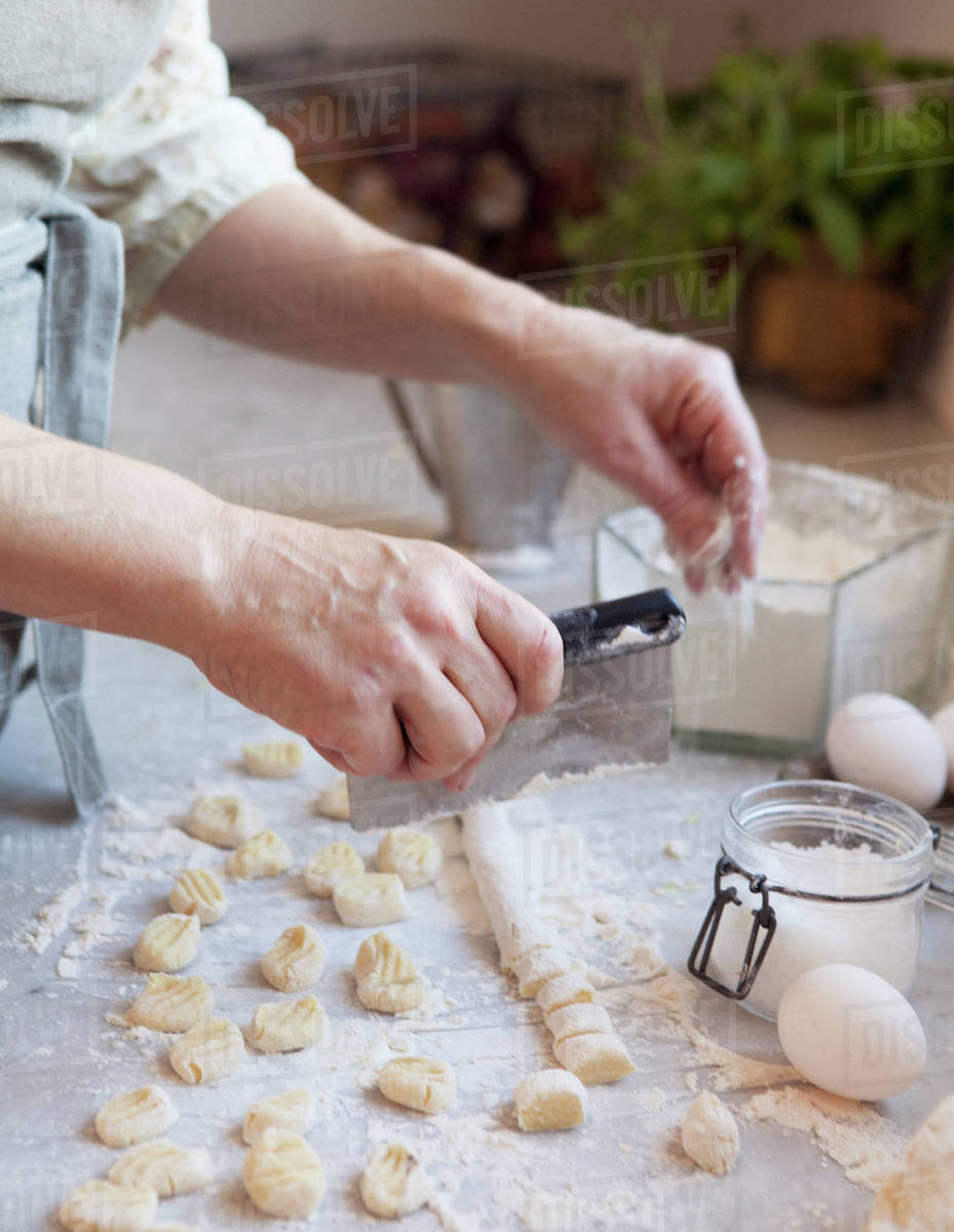 Woman making gnocchi - Stock Photo - Dissolve