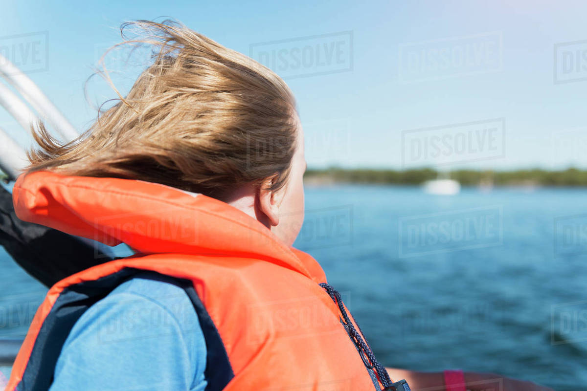 Girl wearing life jacket looking at view - Stock Photo - Dissolve