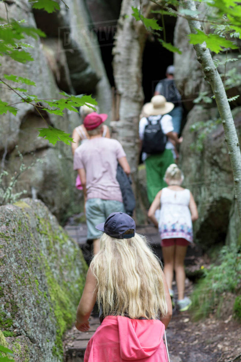 Family walking among rocks - Stock Photo - Dissolve