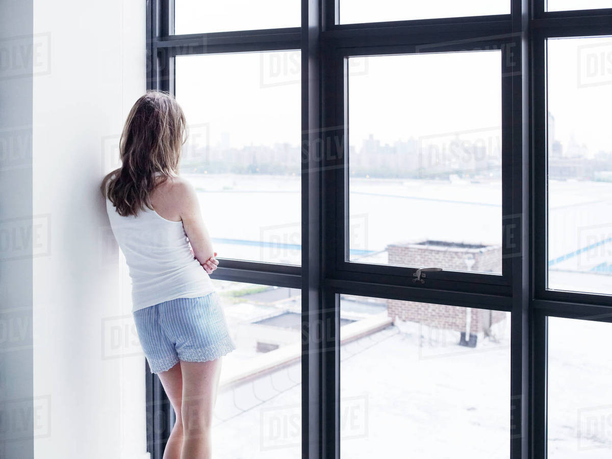 Girl looking through window - Royalty-free Stock Photo | Dissolve
