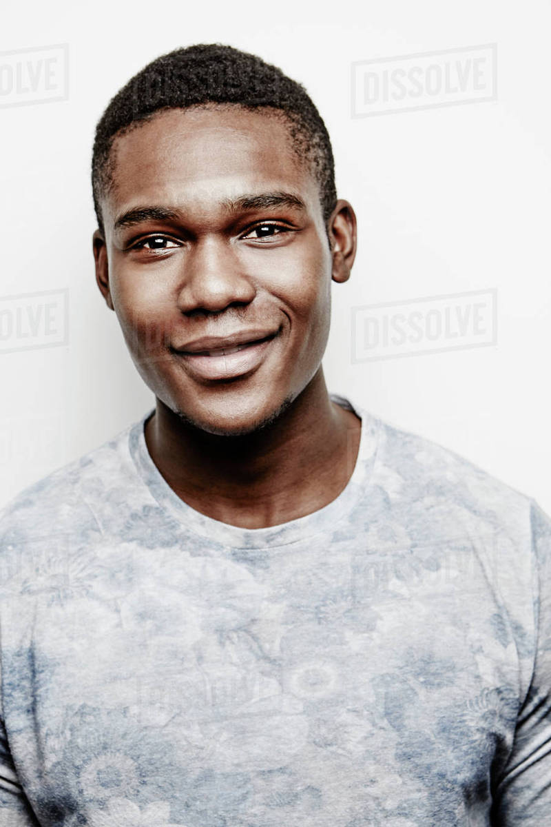 Portrait of young man, studio shot - Stock Photo - Dissolve