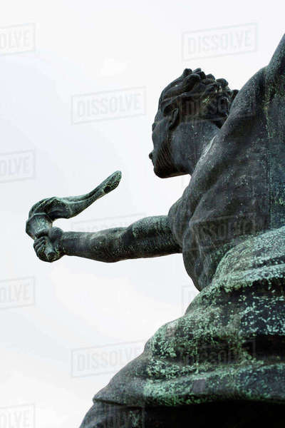 Statue of man holding torch - Royalty-free Stock Photo | Dissolve