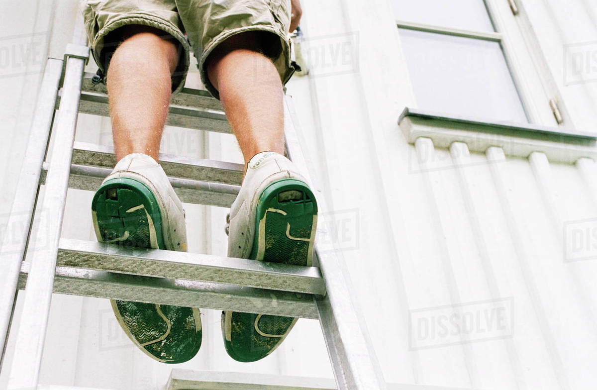 Man standing on ladder, low angle view - Royalty-free Stock Photo ...