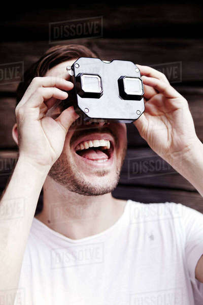 Man looking through viewfinder - Royalty-free Stock Photo | Dissolve