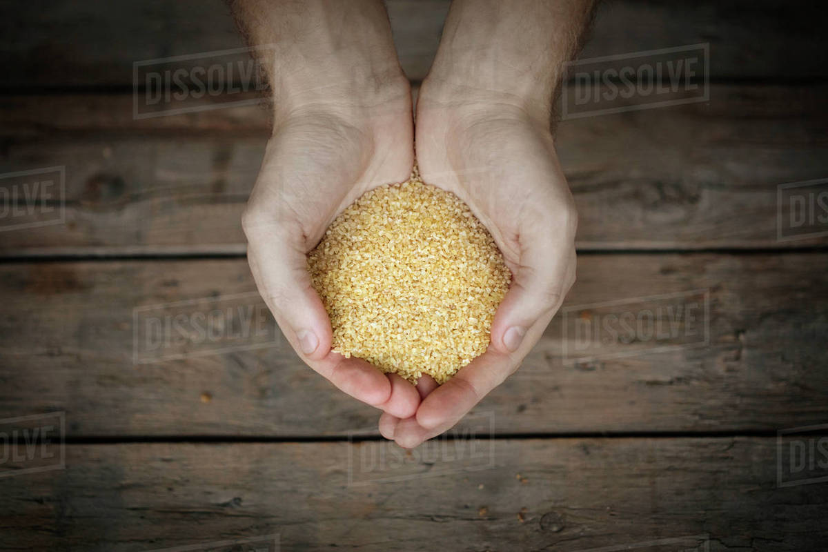 Millets in mans hands, close-up - Royalty-free Stock Photo | Dissolve