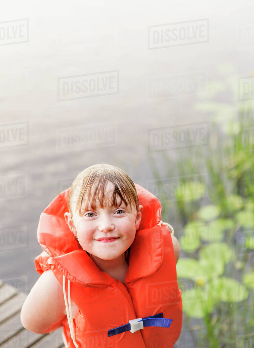 Smiling girl at water - Royalty-free Stock Photo | Dissolve