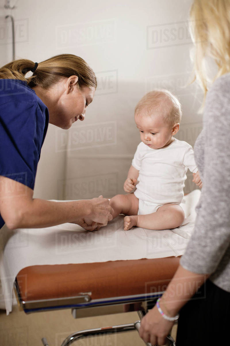 Doctor checking baby - Stock Photo - Dissolve
