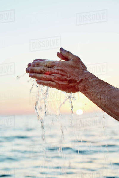 Hand touching water - Stock Photo - Dissolve