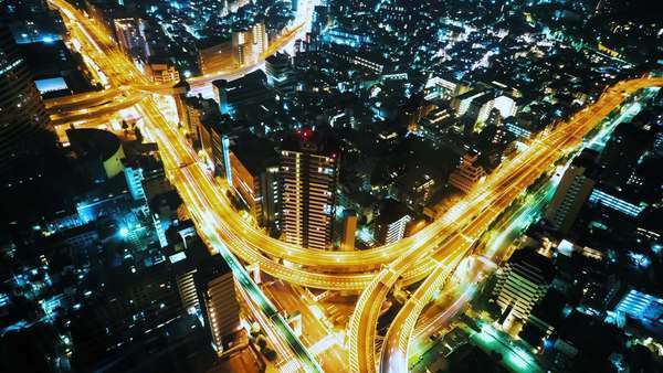 Night becomes day over a massive highway intersection in Shinjuku ...