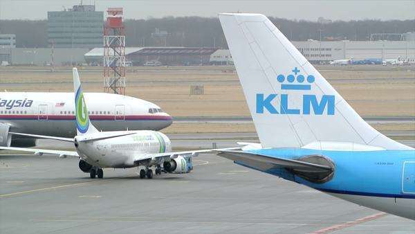 Malaysia Airlines Boeing 777 and Transavia airplanes taxiing at ...