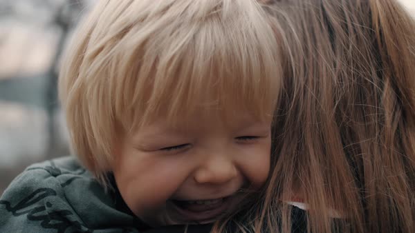 Laughing baby boy face hugging mother enjoy happy childhood with ...