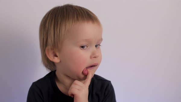 Close up portrait of doubt little cute child feeling confused hesitate ...