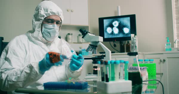 A lab technician or research scientist with a sample of the Wuhan ...