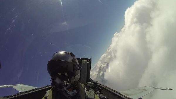 A pilot or passenger is shown flying in a F18 fighter plane, the clouds ...