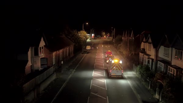 Repair vehicles exiting urban site at night in UK - Stock Video Footage ...