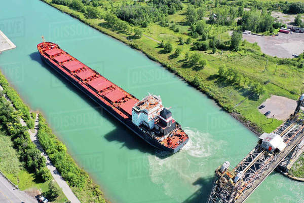 An aerial scene of a Lake Freighter travelling in the Welland Canal ...
