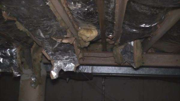 Panning left to right of crawl space (under house) and look at ...