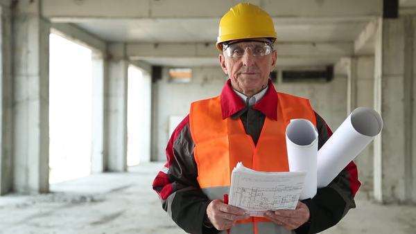 Chief superintendent engineer in yellow hard hat at construction site ...
