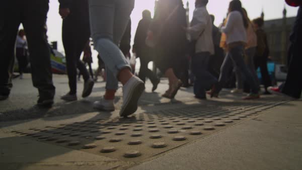 Low angle view, anonymous diverse crowd of people walking through the ...