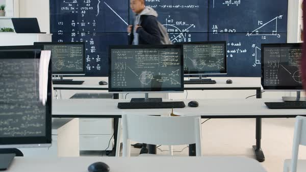 Adult student group arriving for class with math formulas and drawings ...