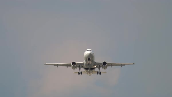 Big passenger airplane taking off. Airliner retracts landing gear after ...