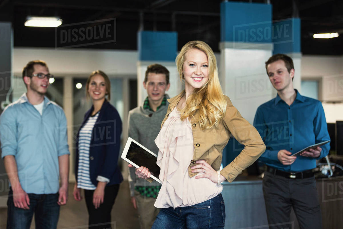 Portrait of a group of young millennial professionals standing together ...