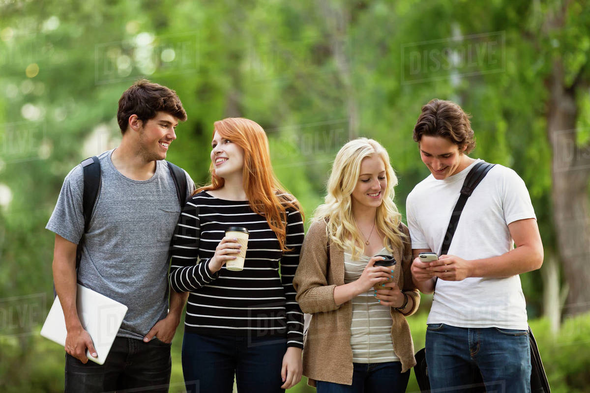 Four friends walking and talking on the university campus; Edmonton ...