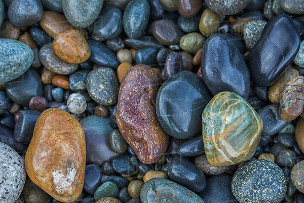 Multi-coloured rocks line the shoreline at Agate Beach, Naikoon ...
