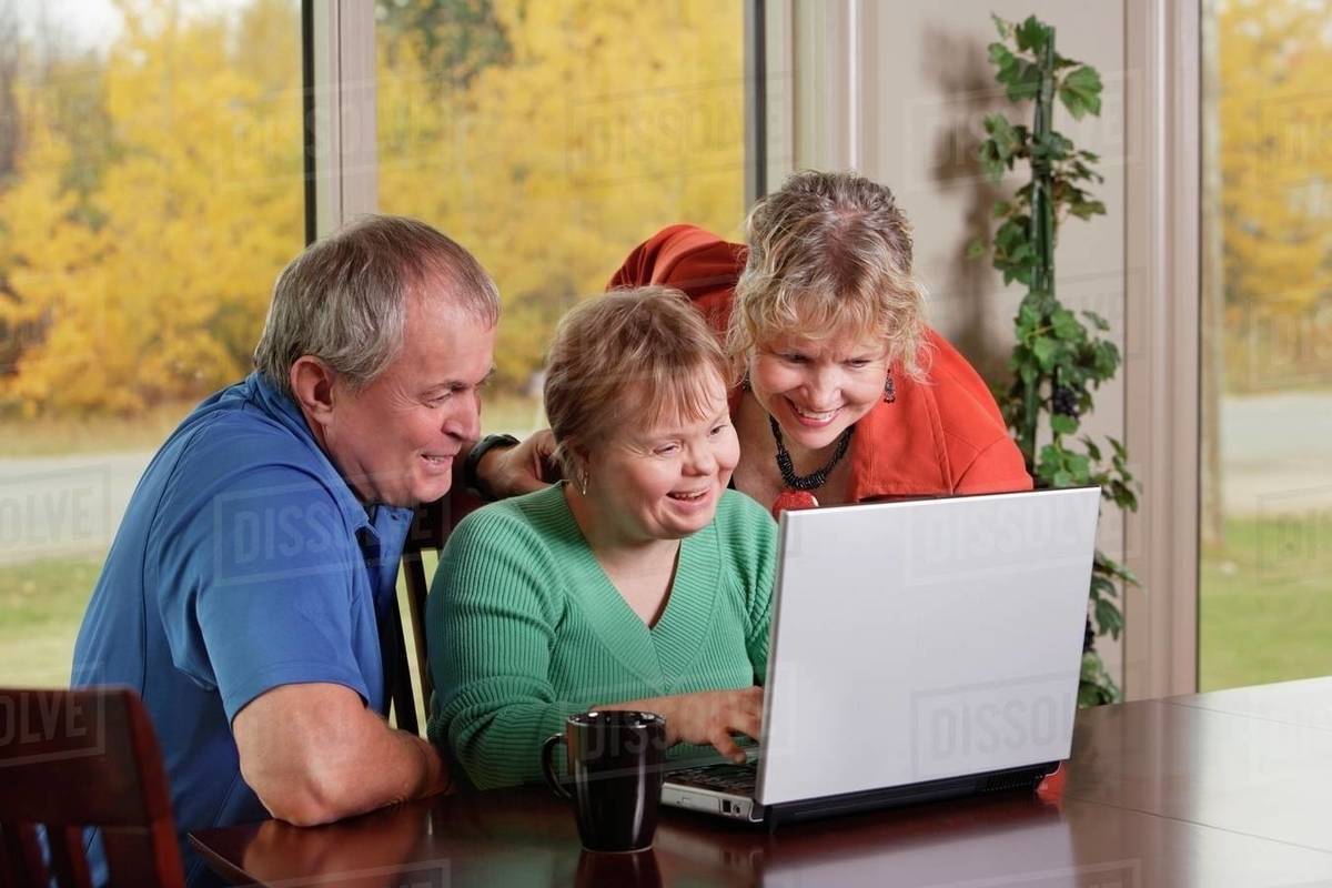 Family With Down Syndrome Daughter Using Laptop Computer - Royalty-free ...