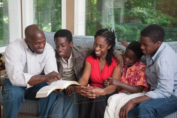 A Christian Family Reading Bible - Royalty-free Stock Photo | Dissolve