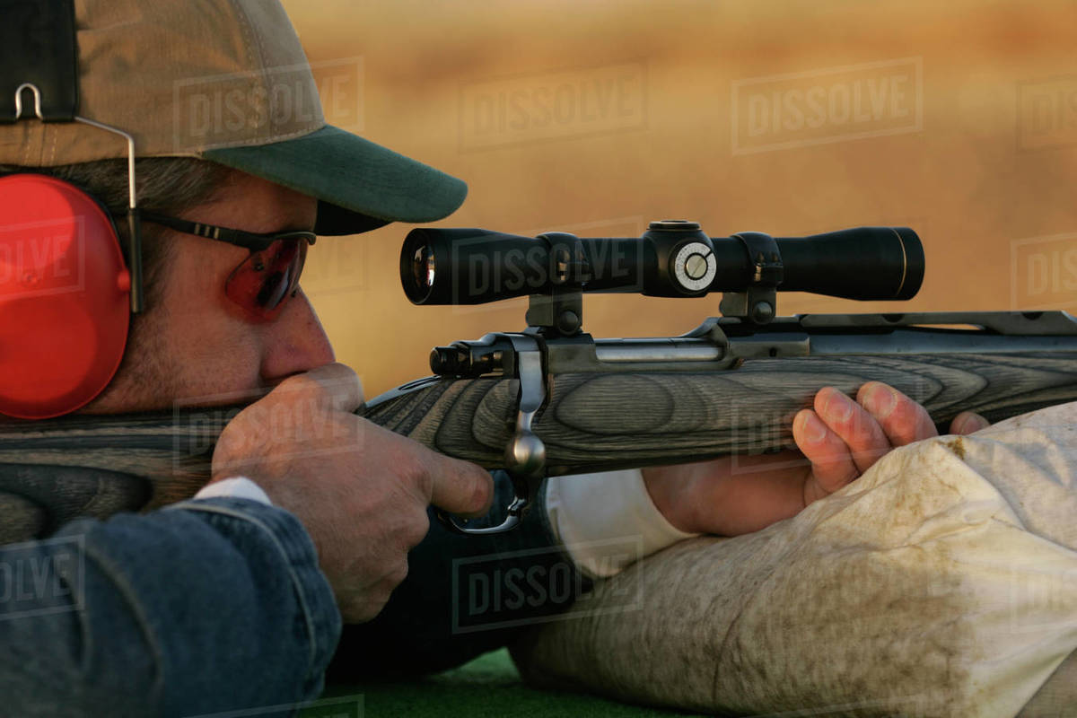 Man Shooting Rifle On Shooting Range - Stock Photo - Dissolve