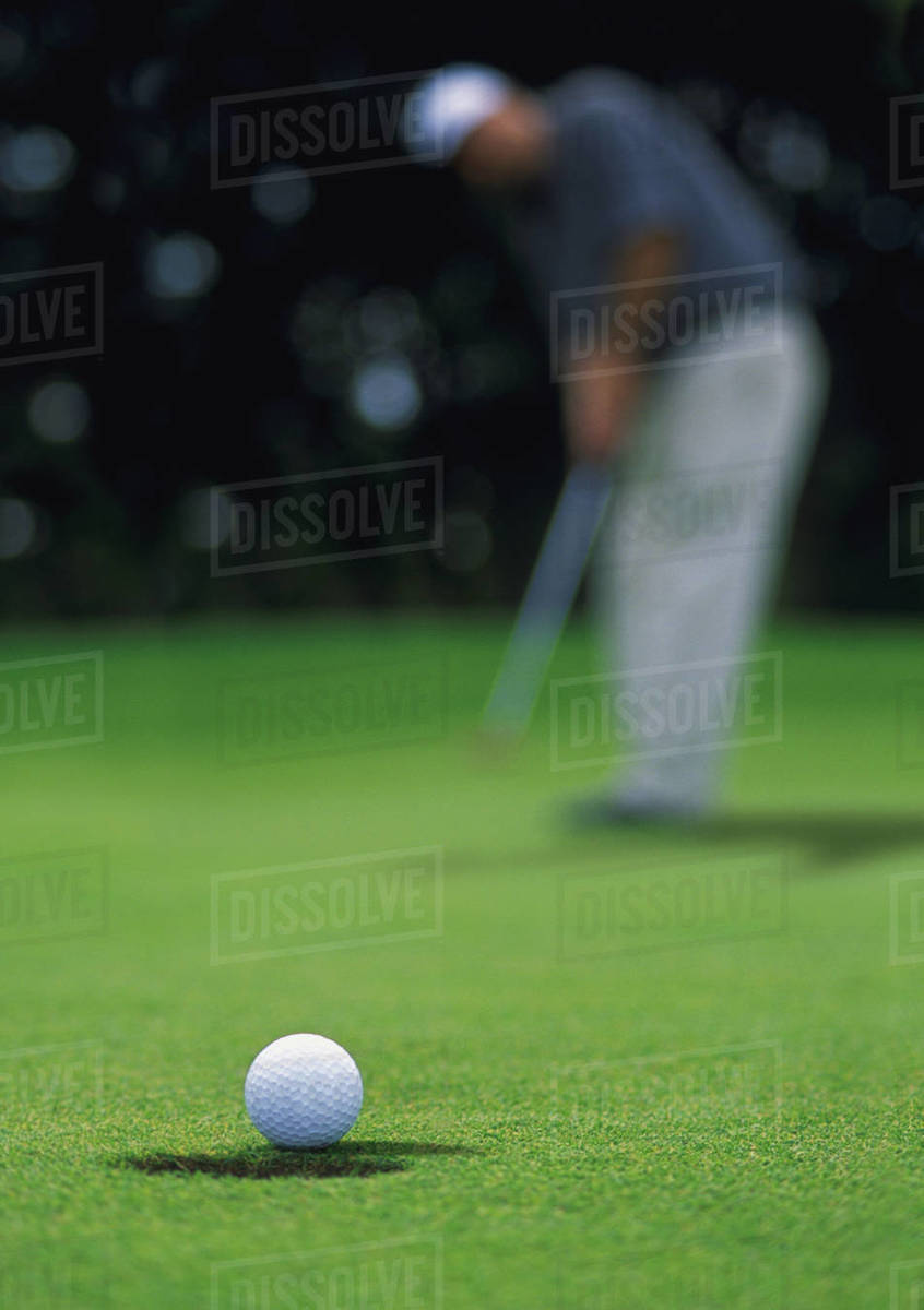 Man Putting - Stock Photo - Dissolve