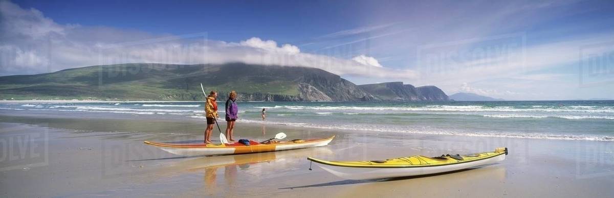 Keel Bay, Achill Island, County Mayo, Ireland; Two People Standing Near ...