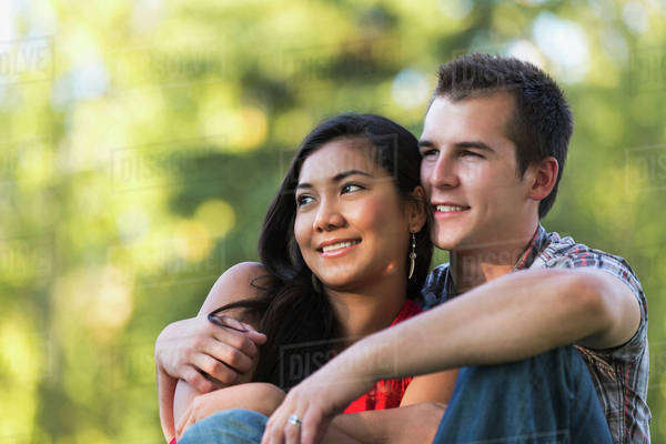 Mixed race couple spending quality time together in a park in autumn ...