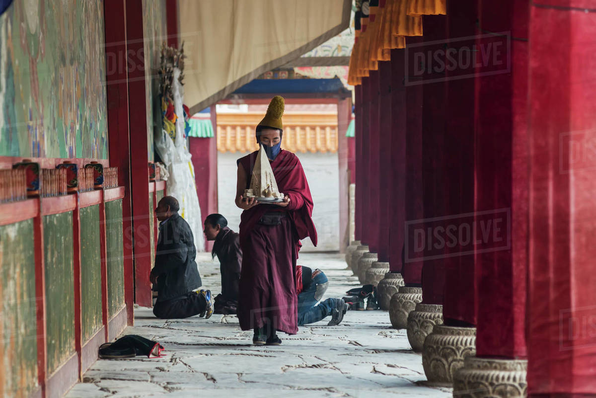 A Monk Carrying An Artifact Of Buddhist Praying Ceremony At Labrang ...